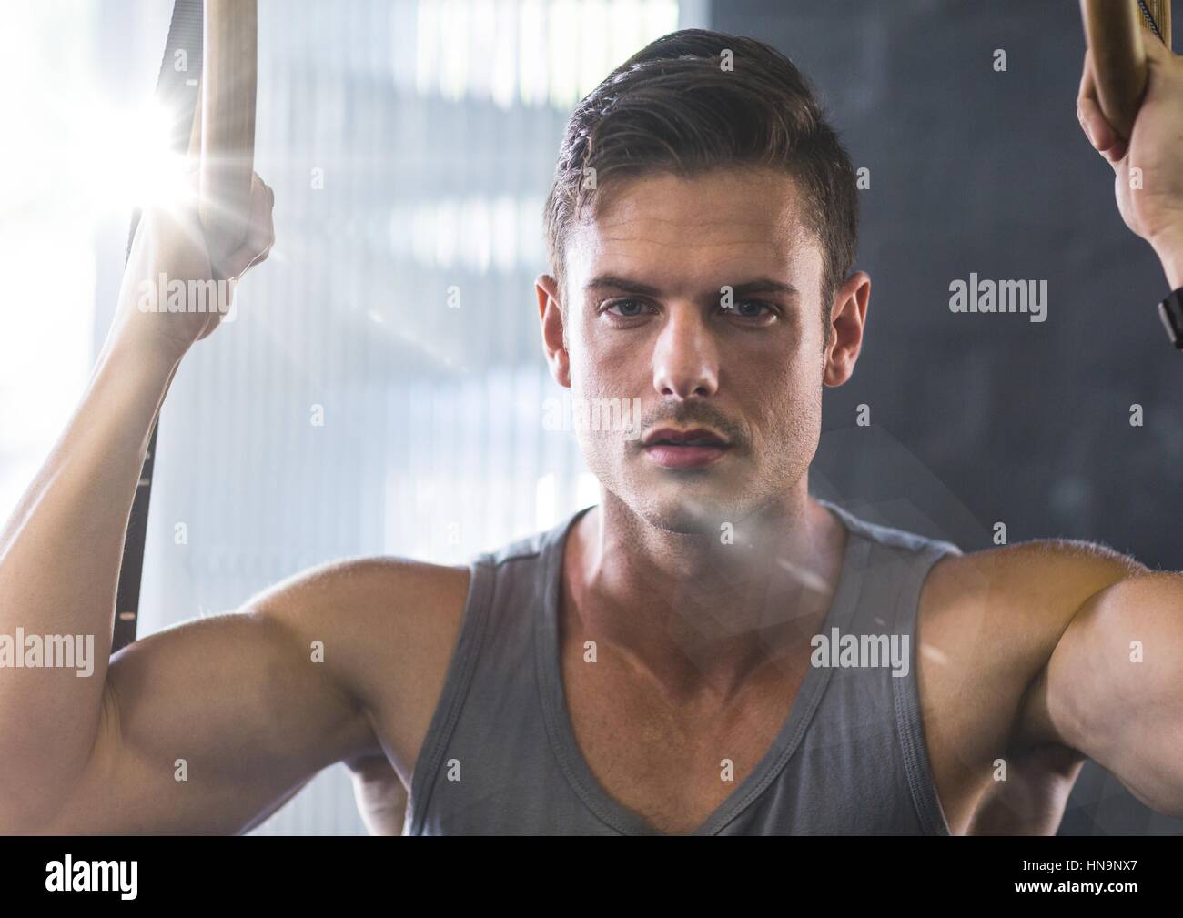 Digital composite of Man doing pull ups with flare Stock Photo - Alamy