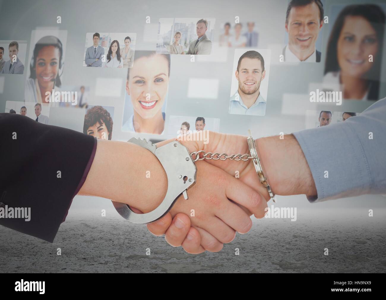 Digital composite of Handshake with handcuffs in front of sky with ...