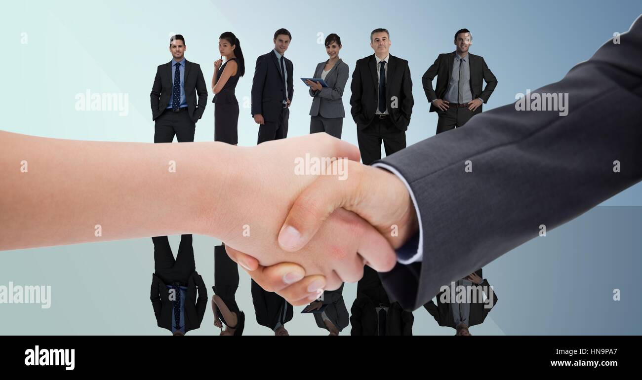 Digital composite of Handshake in front of business people with blue ...