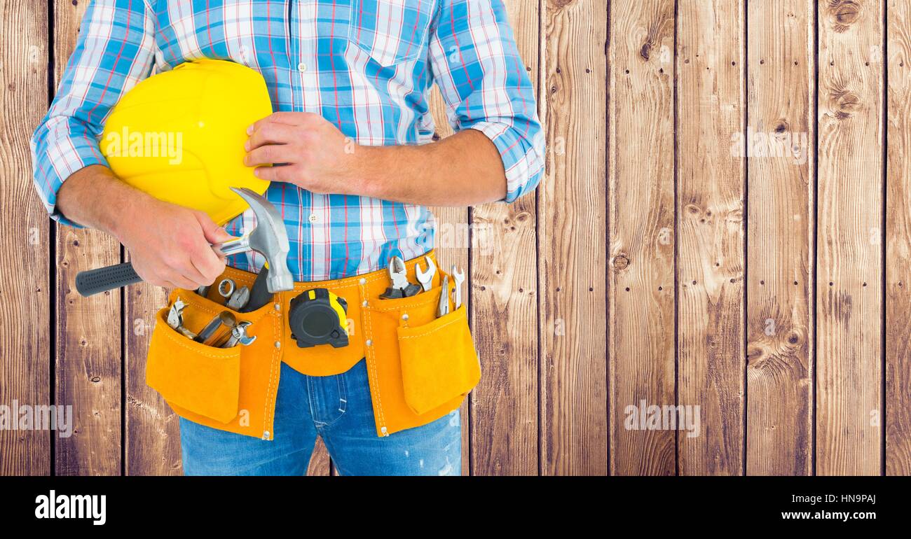 Digital composite of Carpenter with hammer against wood panel Stock ...