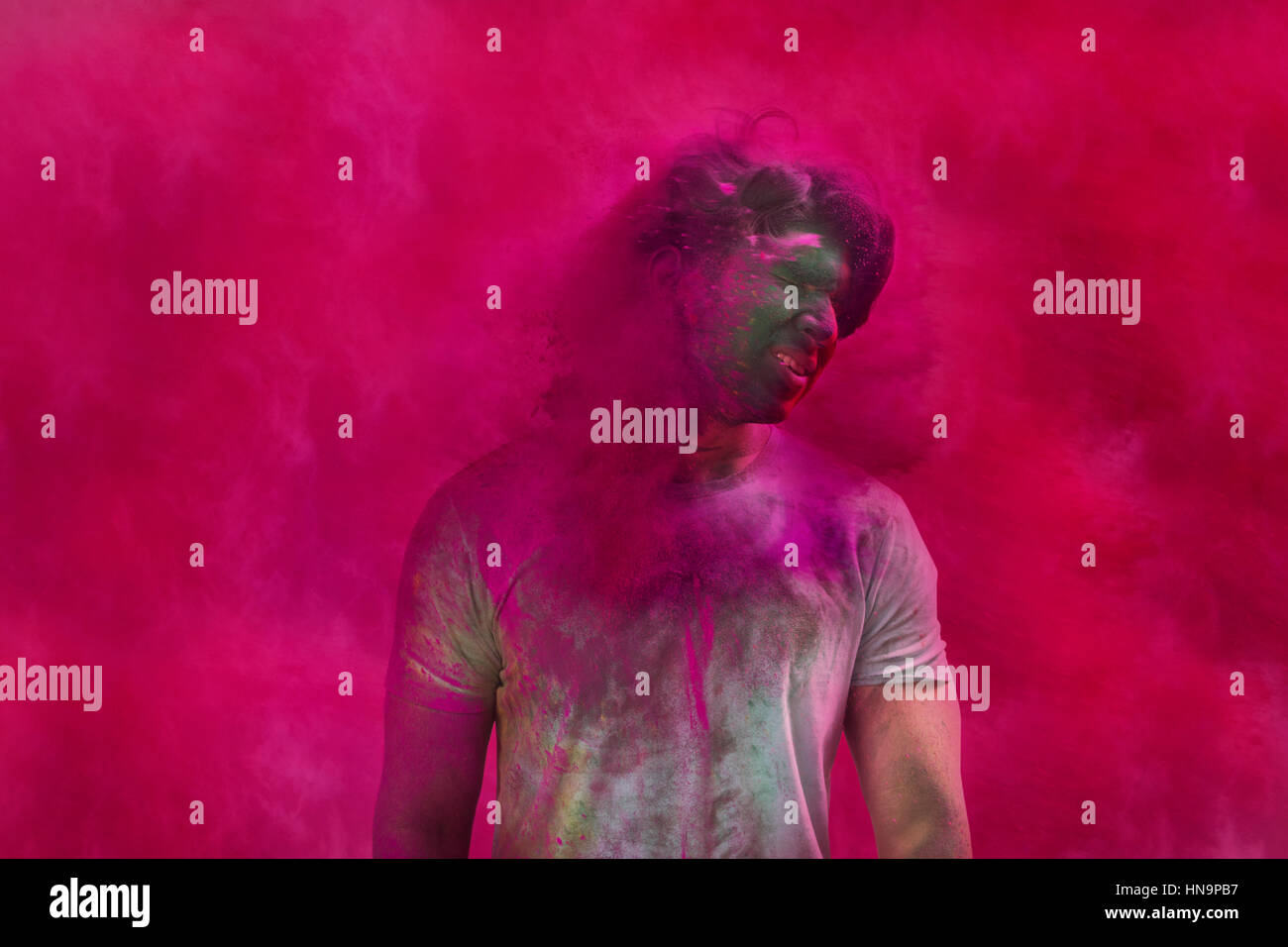Young man with holi colors Stock Photo - Alamy