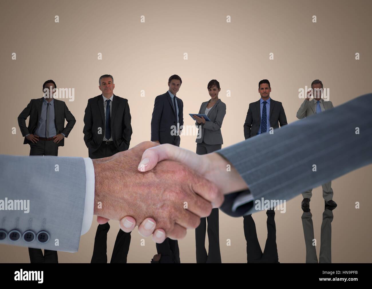 Digital composite of Handshake in front of business people with cream ...