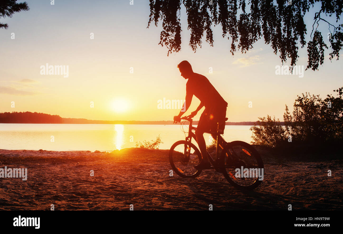 boy on a bicycle at sunset Stock Photo - Alamy