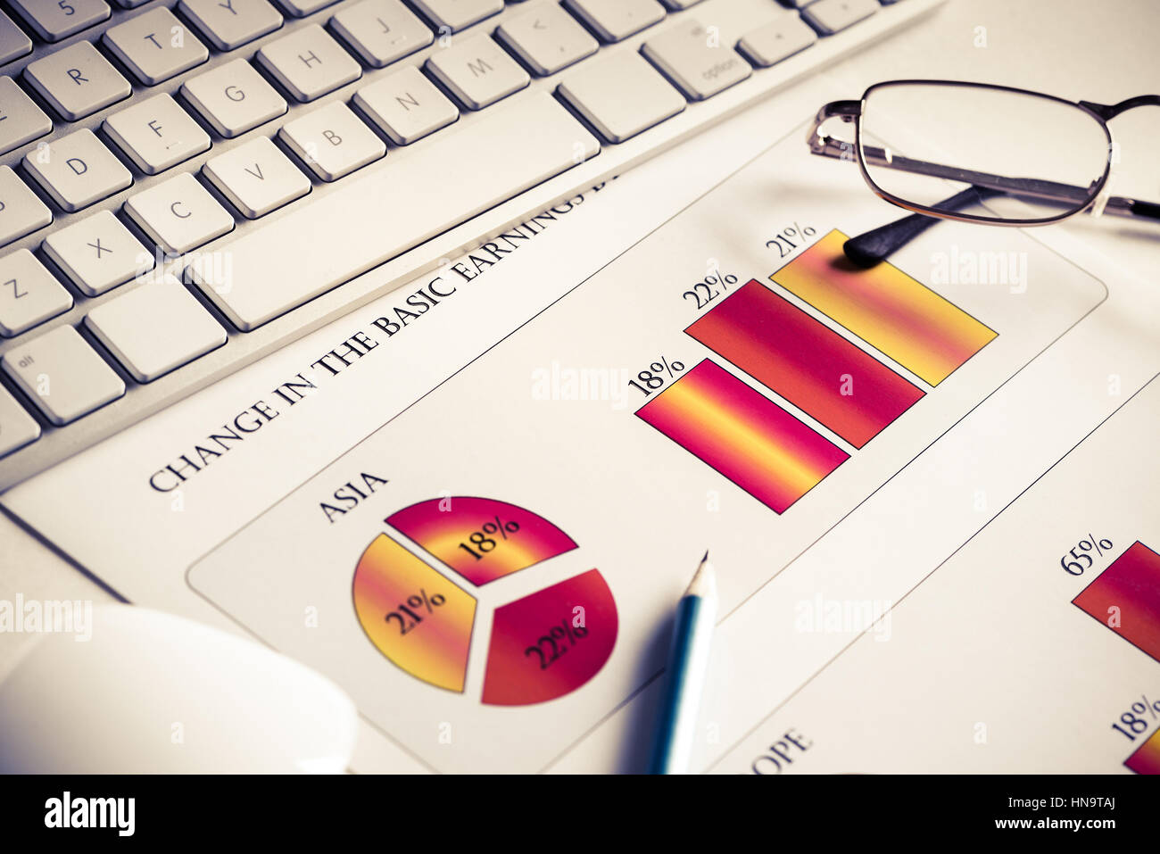 Business workplace with keyboard mouse and papers with graphs and ...