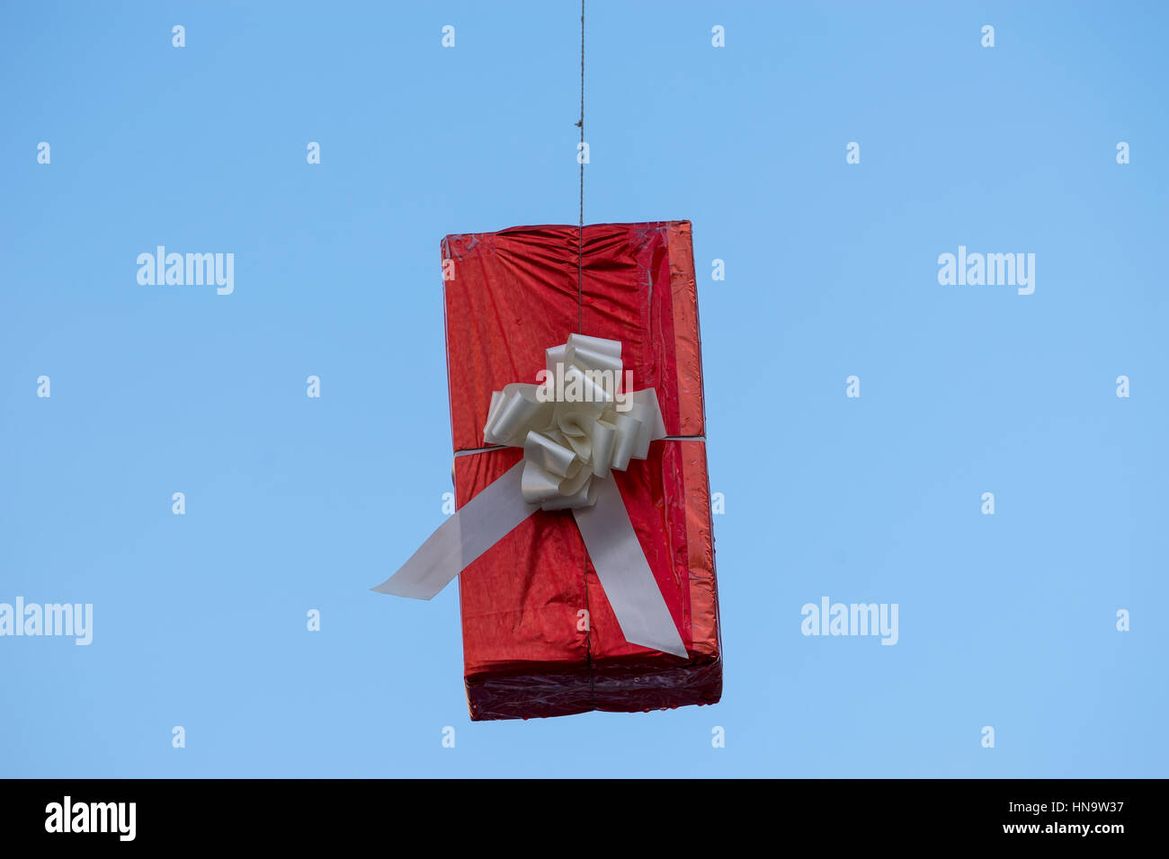 Gift boxes that hang suspended on wires and networks. Street ...