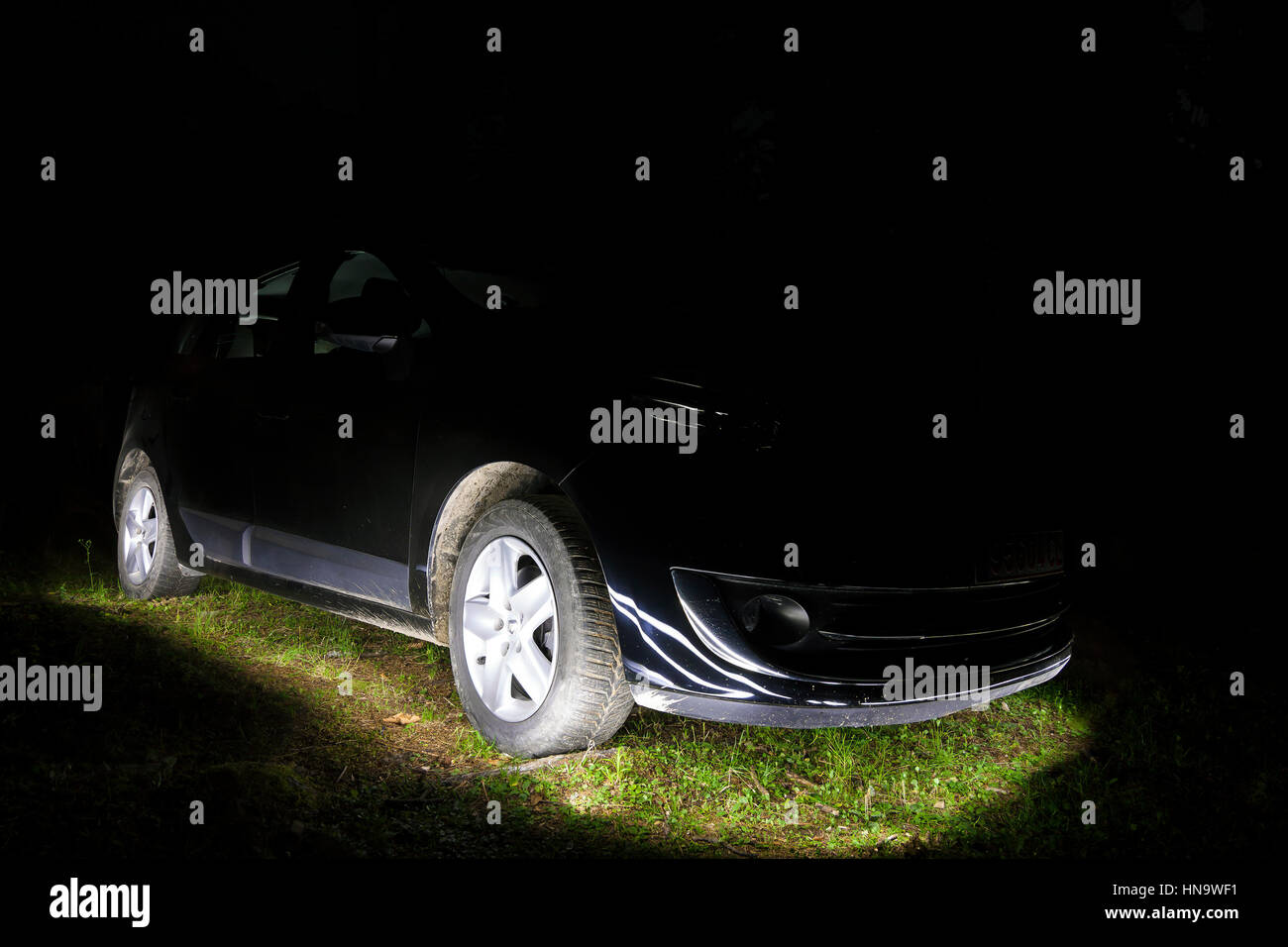 Modern black car illuminated from underneath in night. Arrival of ...
