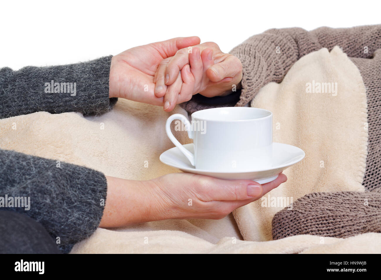 picture of a woman hand giving tea to an elderly woman Stock Photo - Alamy