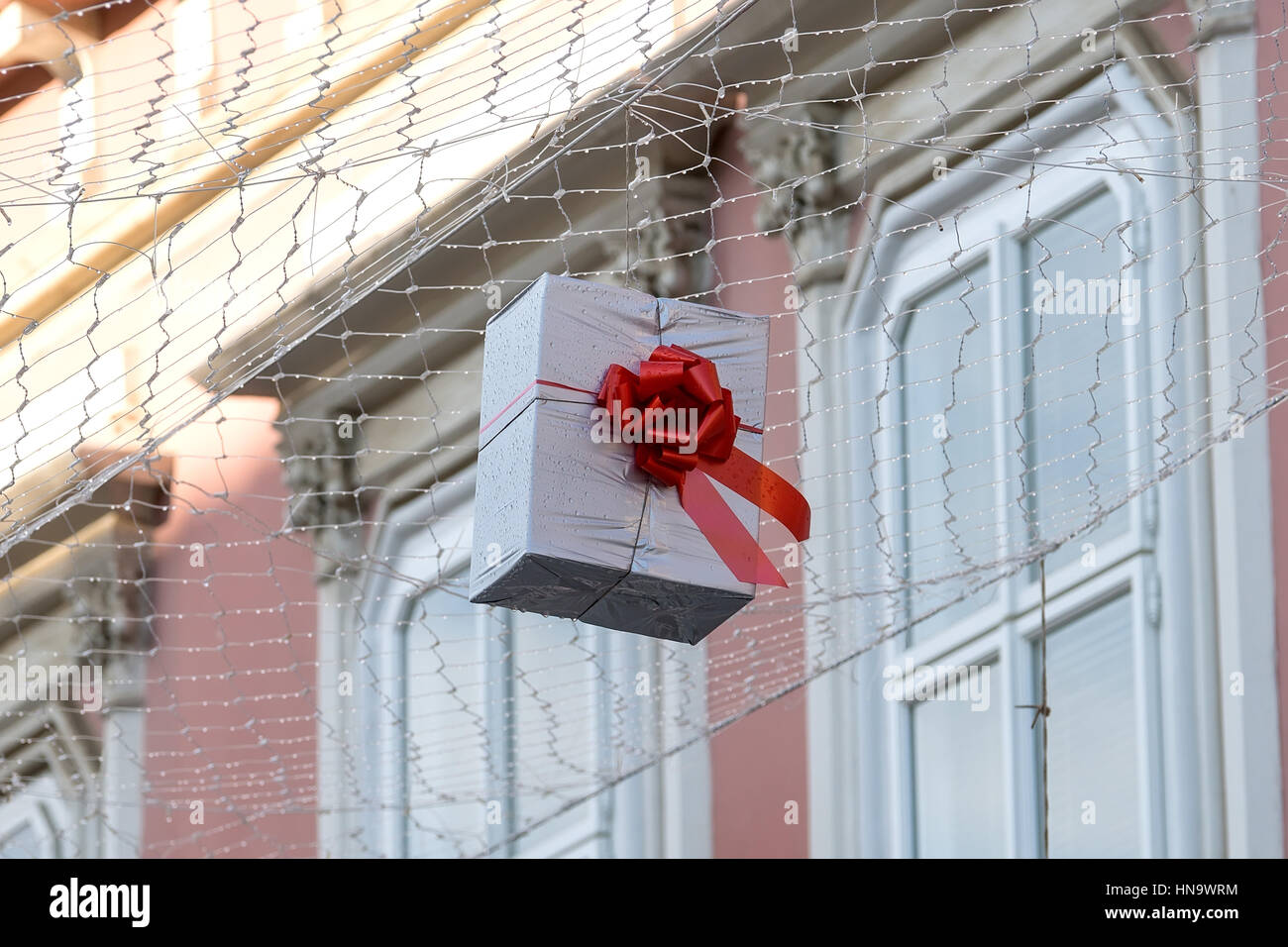 Gift boxes that hang suspended on wires and networks. Street ...