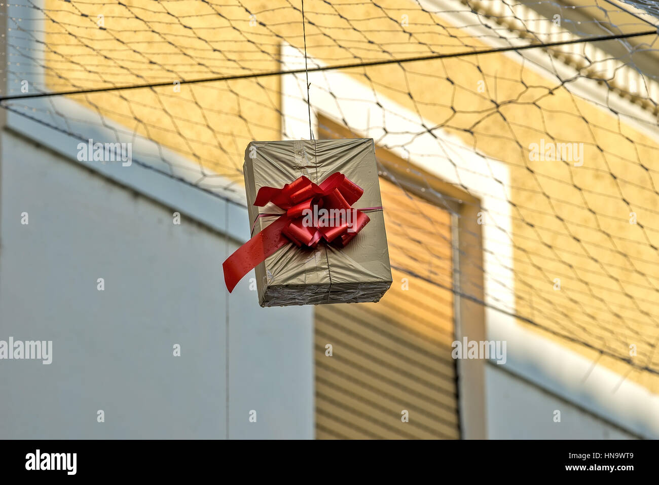Gift boxes that hang suspended on wires and networks. Street ...