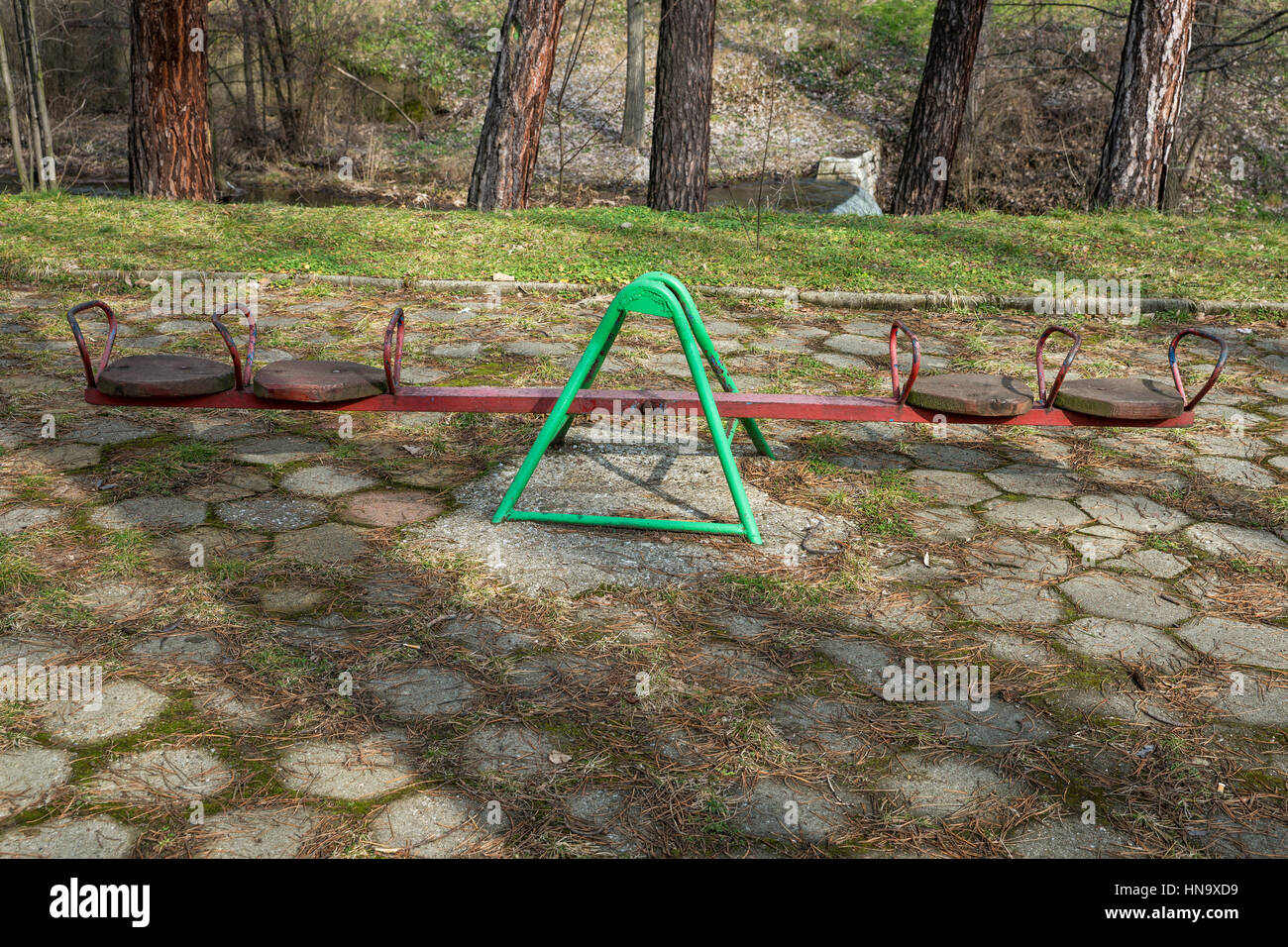 Colorful seesaw in a park behind the river Stock Photo - Alamy