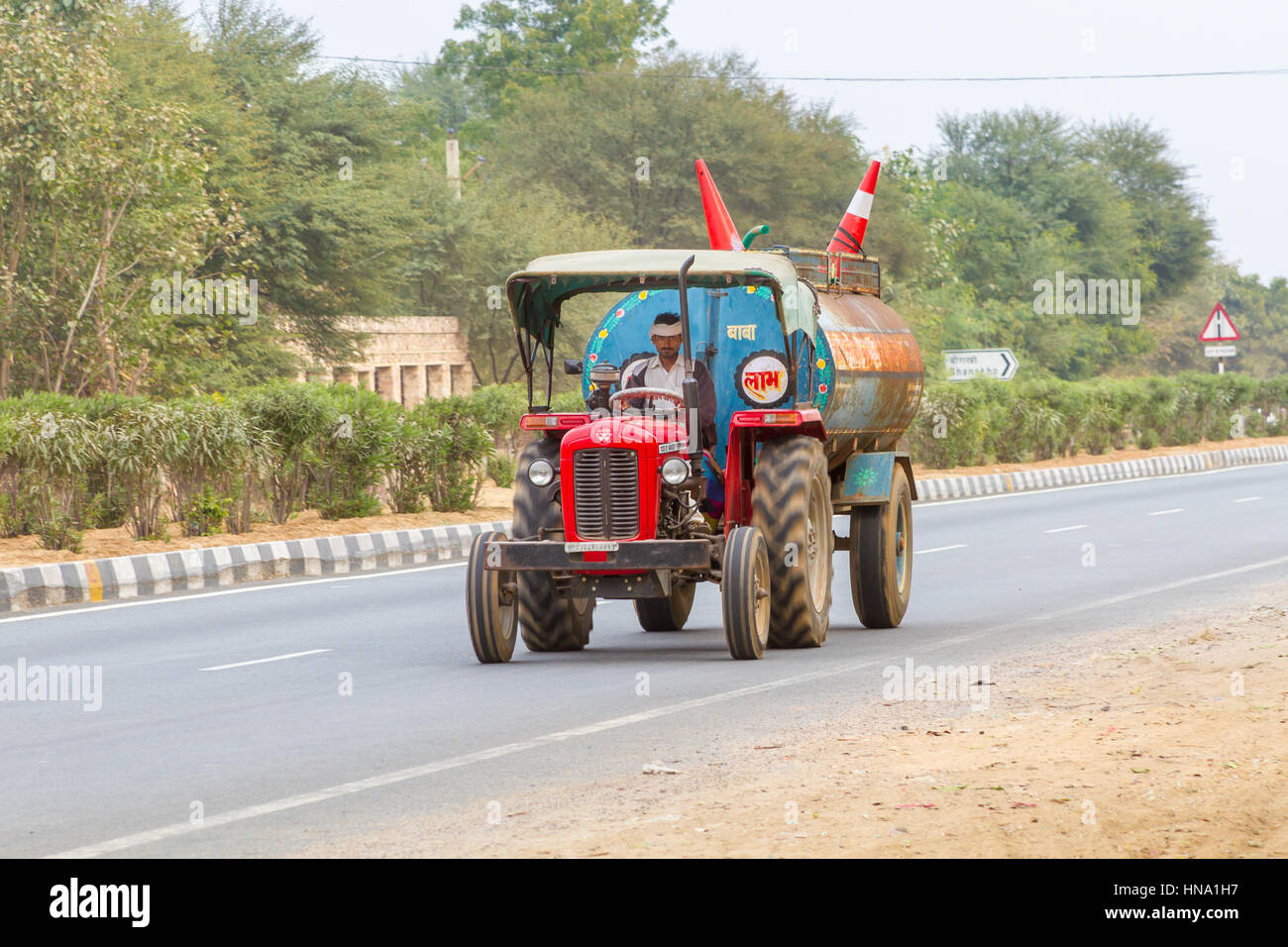 Rajasthan, INDIA, 21st January 2017 - A small tractor-tanker driving ...