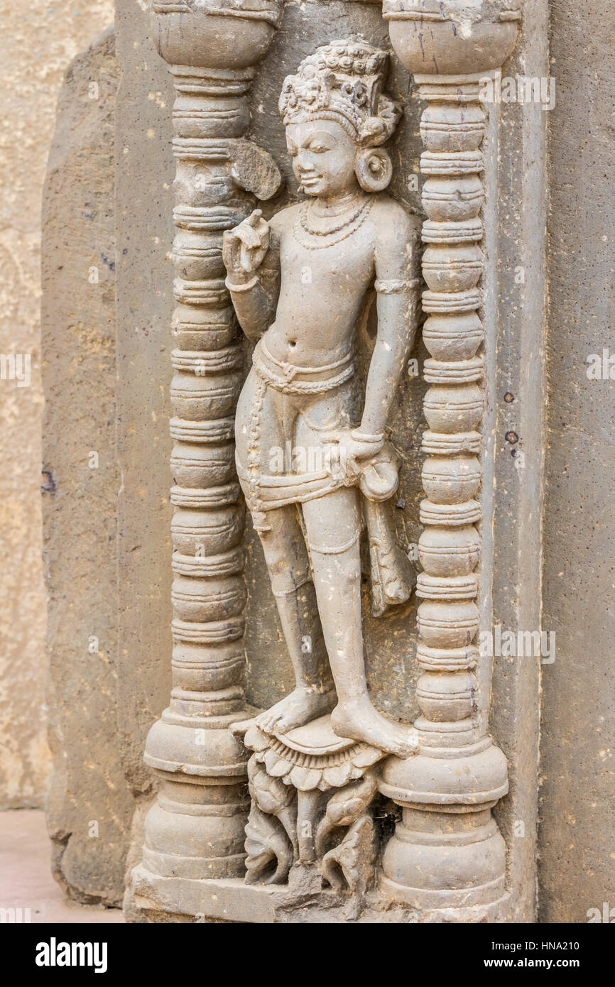 A carving of an Apsara (heavenly nymph) at the Chand Baori stepwell in ...