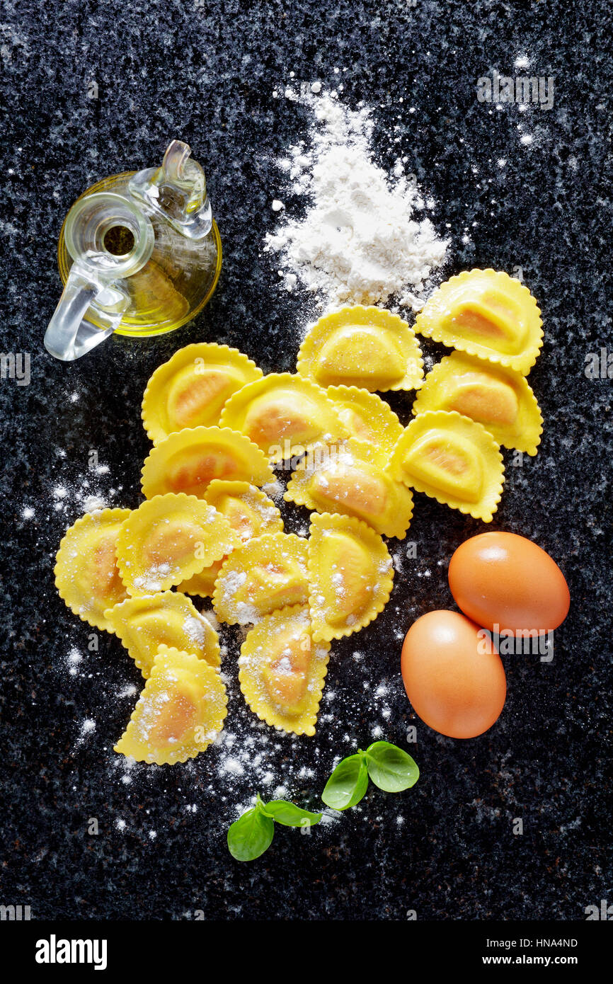 delicious fresh cooked homemade Ravioli on a dark marble surface. eggs ...