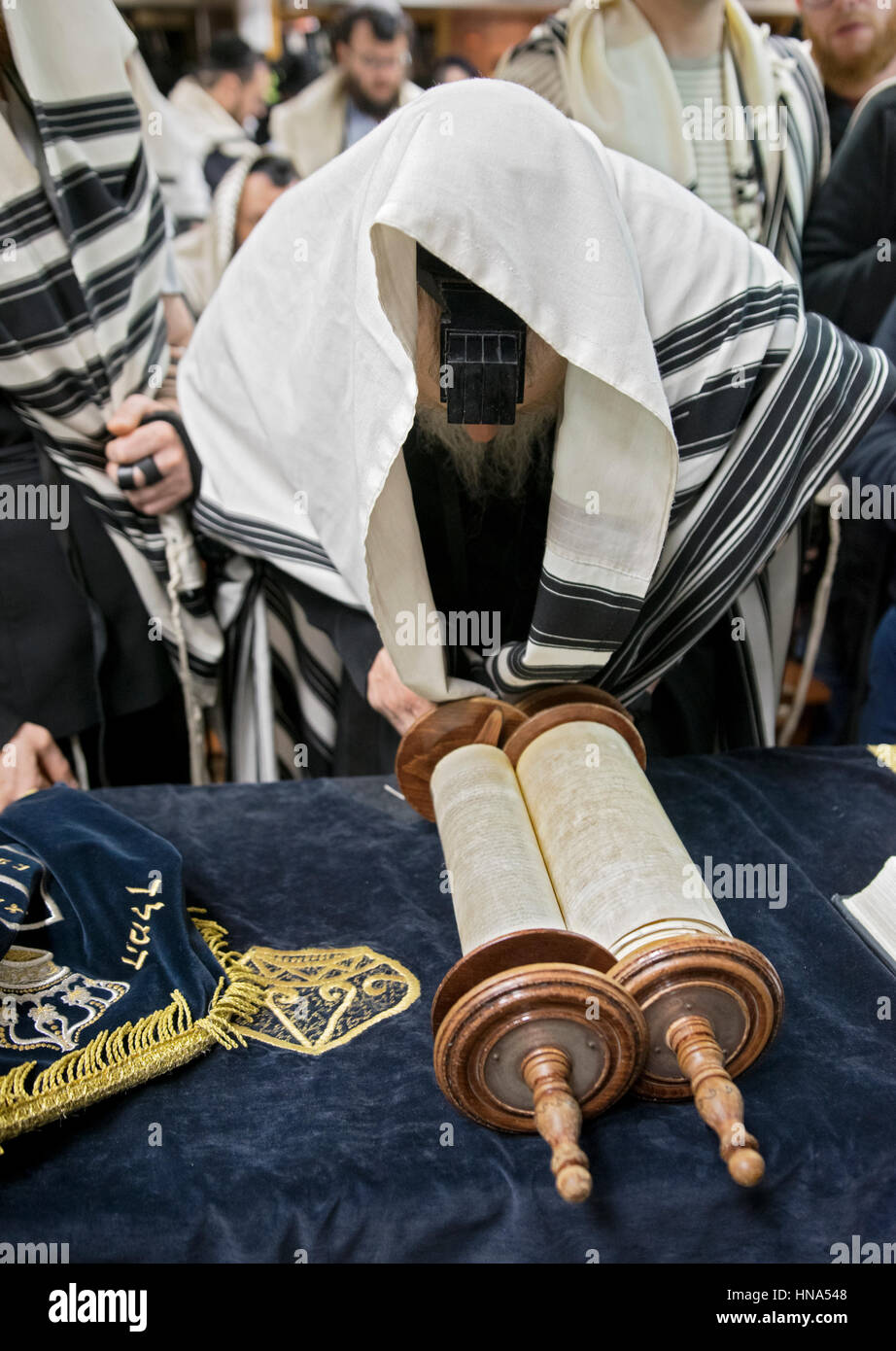 At orthodox Jewish morning services, a man called to the Torah makes a ...