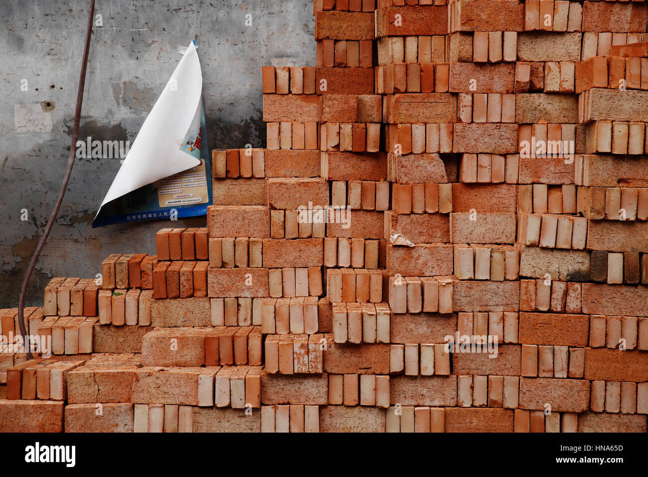Bricks are stacked for a building project in a Hutong, in Beijing ...