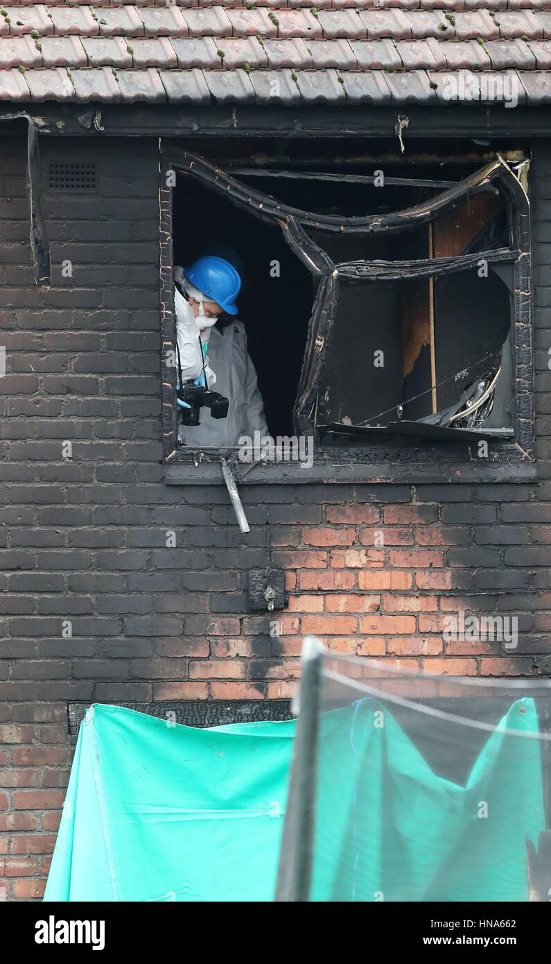 A police forensics officer at the scene in Withington, Manchester ...