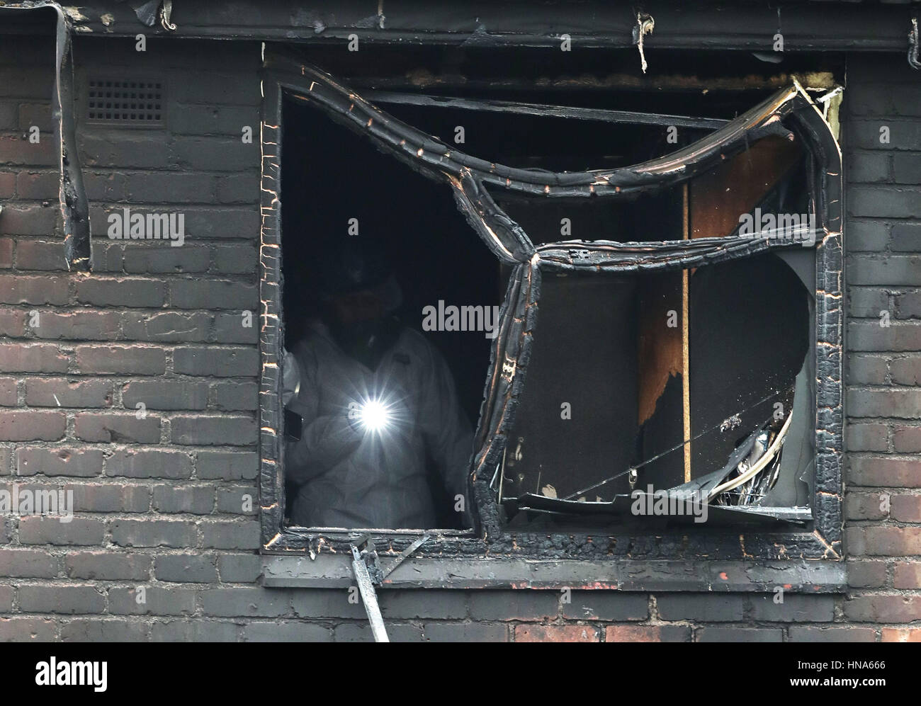 A police forensics officer at the scene in Withington, Manchester ...