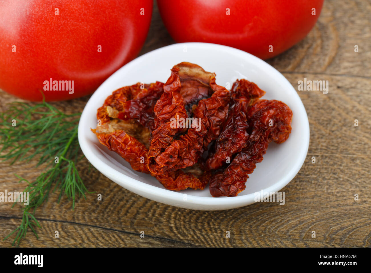 Dry tomato in the bowl with dill and pepper Stock Photo - Alamy