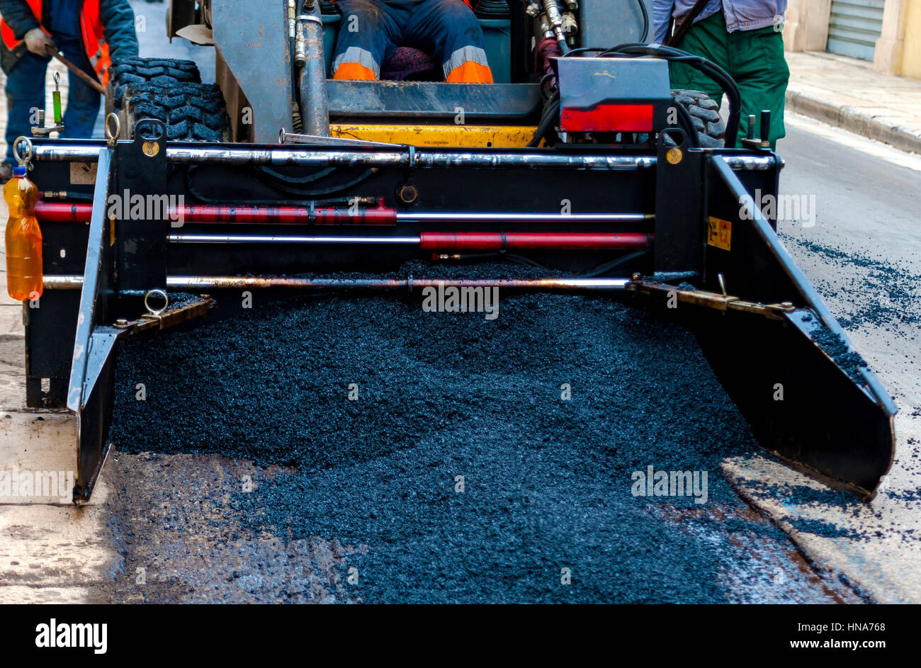 lightl truck laying fresh bitumen and asphalt at road construction site ...