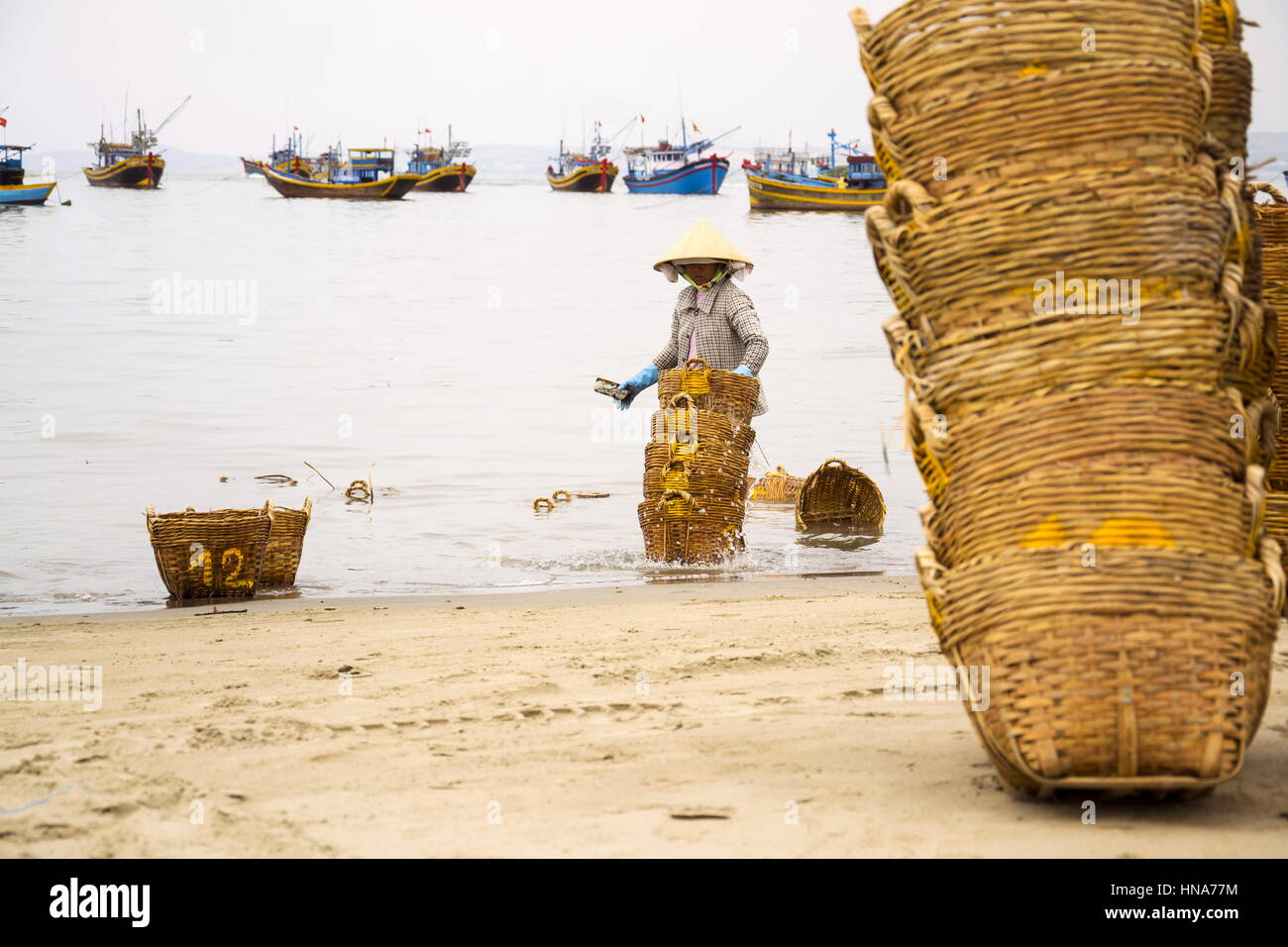 Woman washing baskets on fish sauce production, Mui Ne, Vietnam Stock ...
