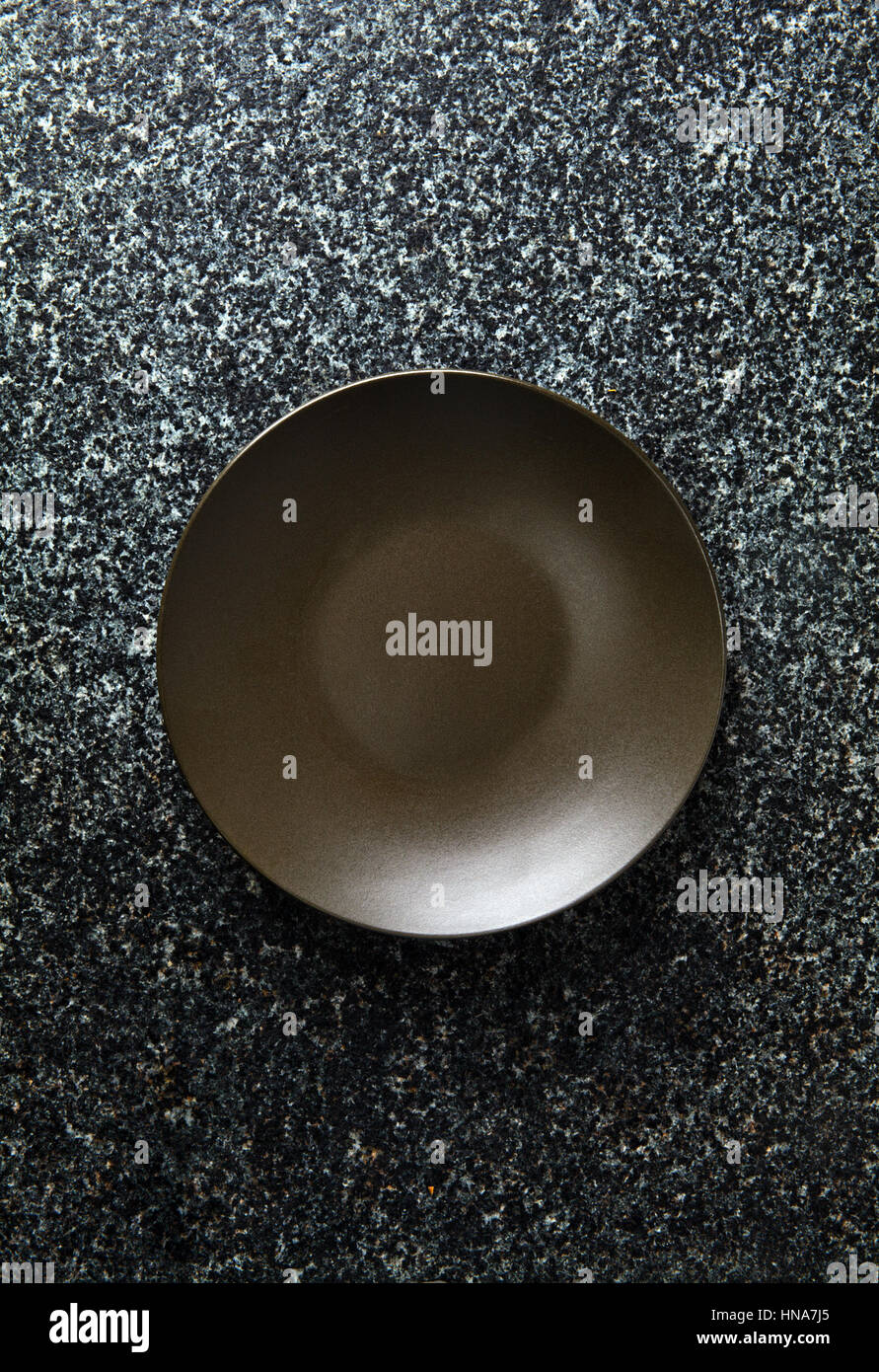 empty dark plate on a marble table. food background Stock Photo - Alamy