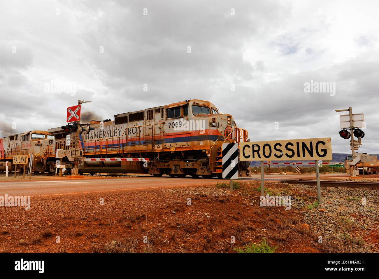 Hamersley Iron Ore locomotive train passing through a level crossing ...