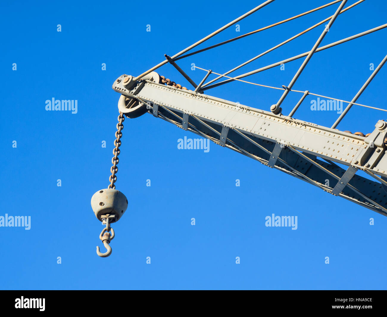 Details of upper part of an old crane: hook, chain, pulley, beam ...
