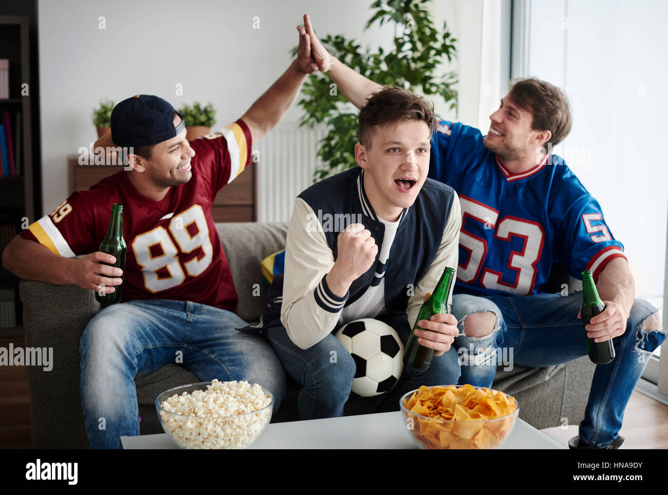 Friends supporting their soccer team Stock Photo - Alamy