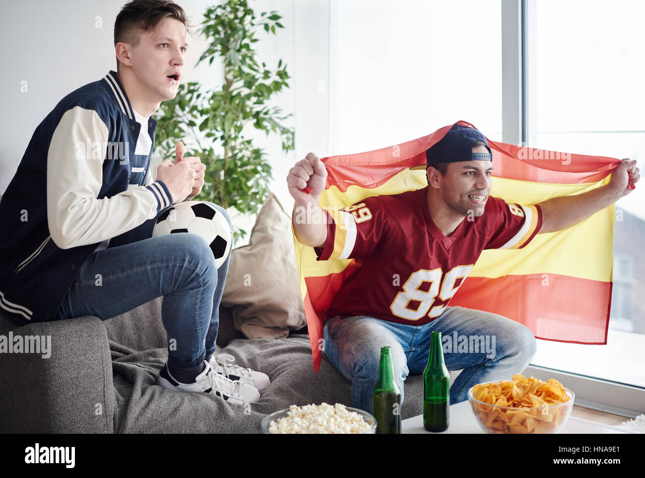 Male fans soccer fan watching game Stock Photo - Alamy