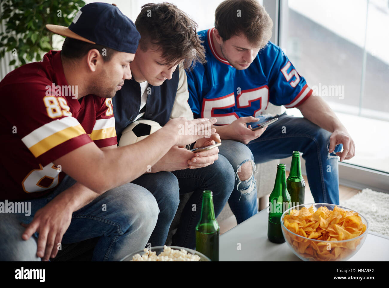 Checking game stats on a phone Stock Photo - Alamy
