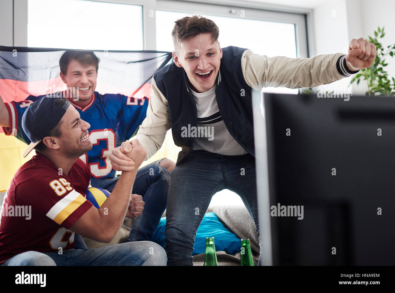Friends watching exciting sports game Stock Photo - Alamy