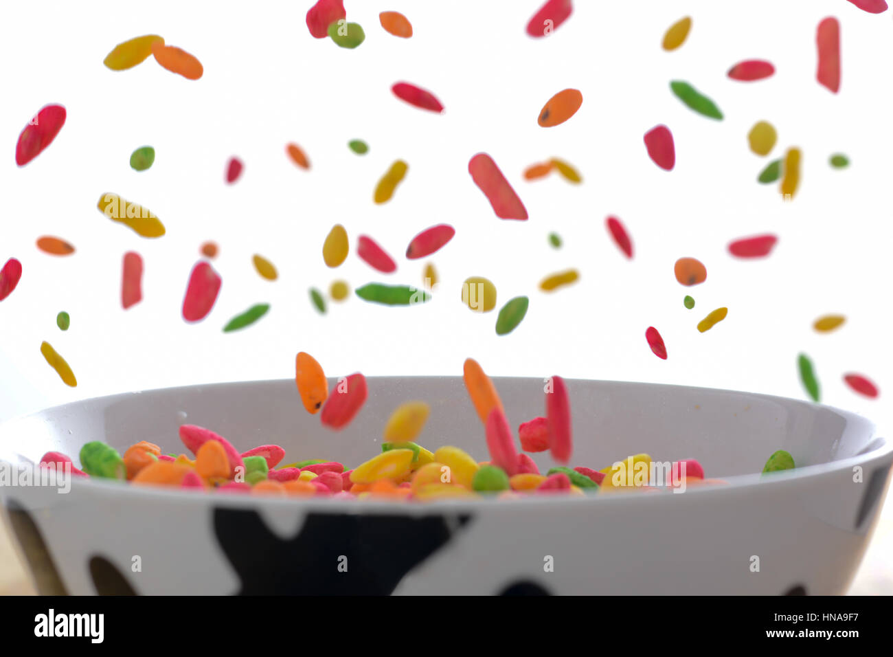 Colorful rice falling in the bowl on the white background Stock Photo ...