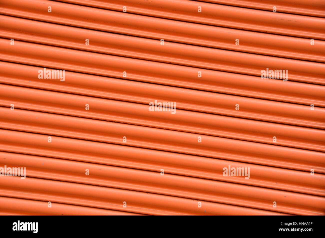 Close-up of orange steel shutters Stock Photo - Alamy