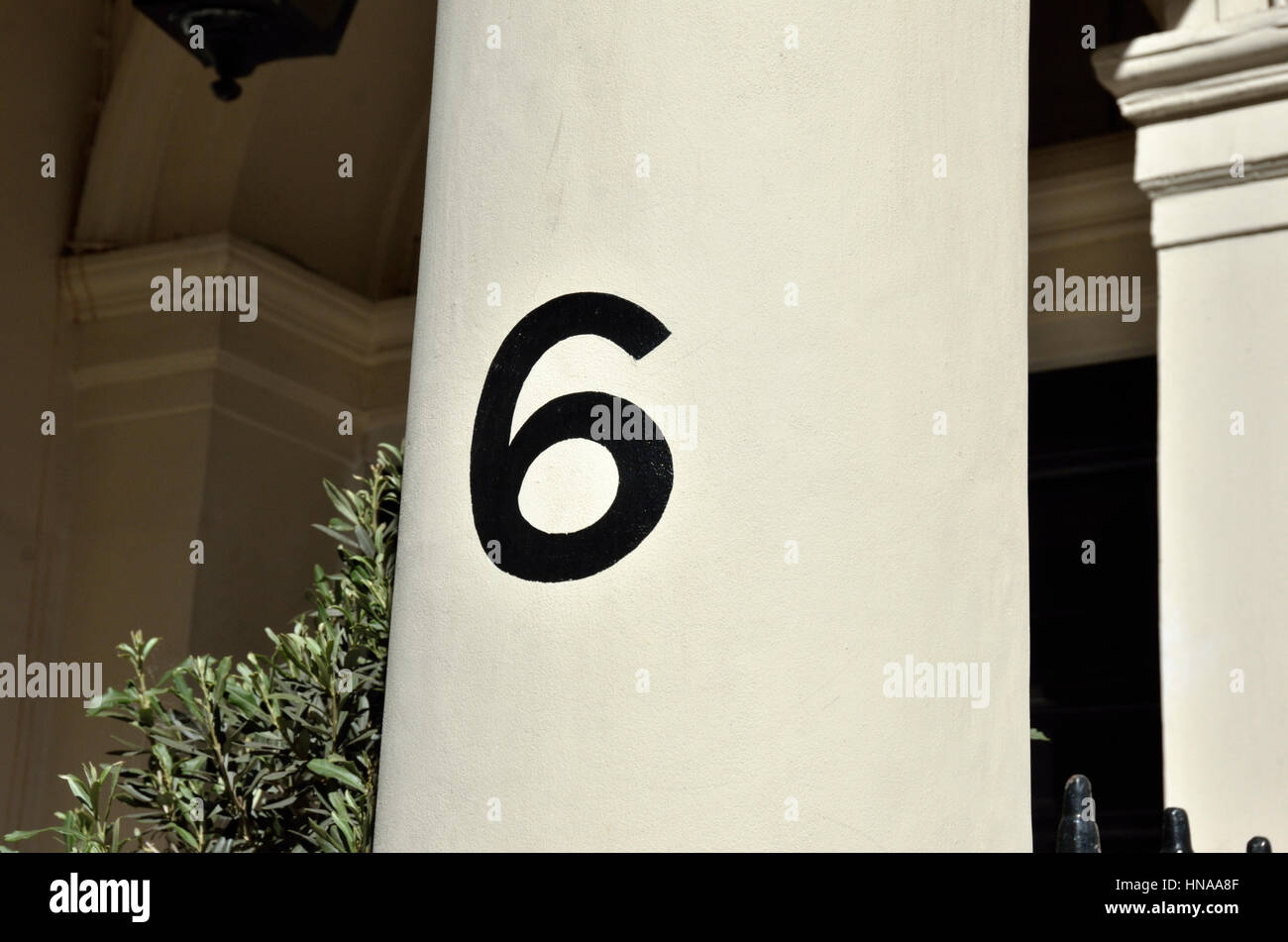 The street number six on a pillar Stock Photo - Alamy