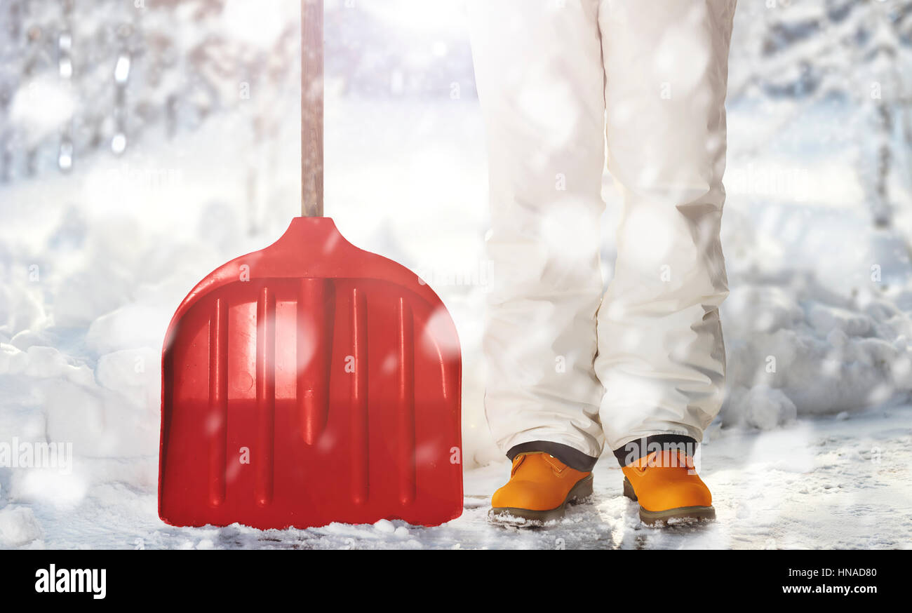 Man Removing snow with a shovel during snowfall Stock Photo - Alamy