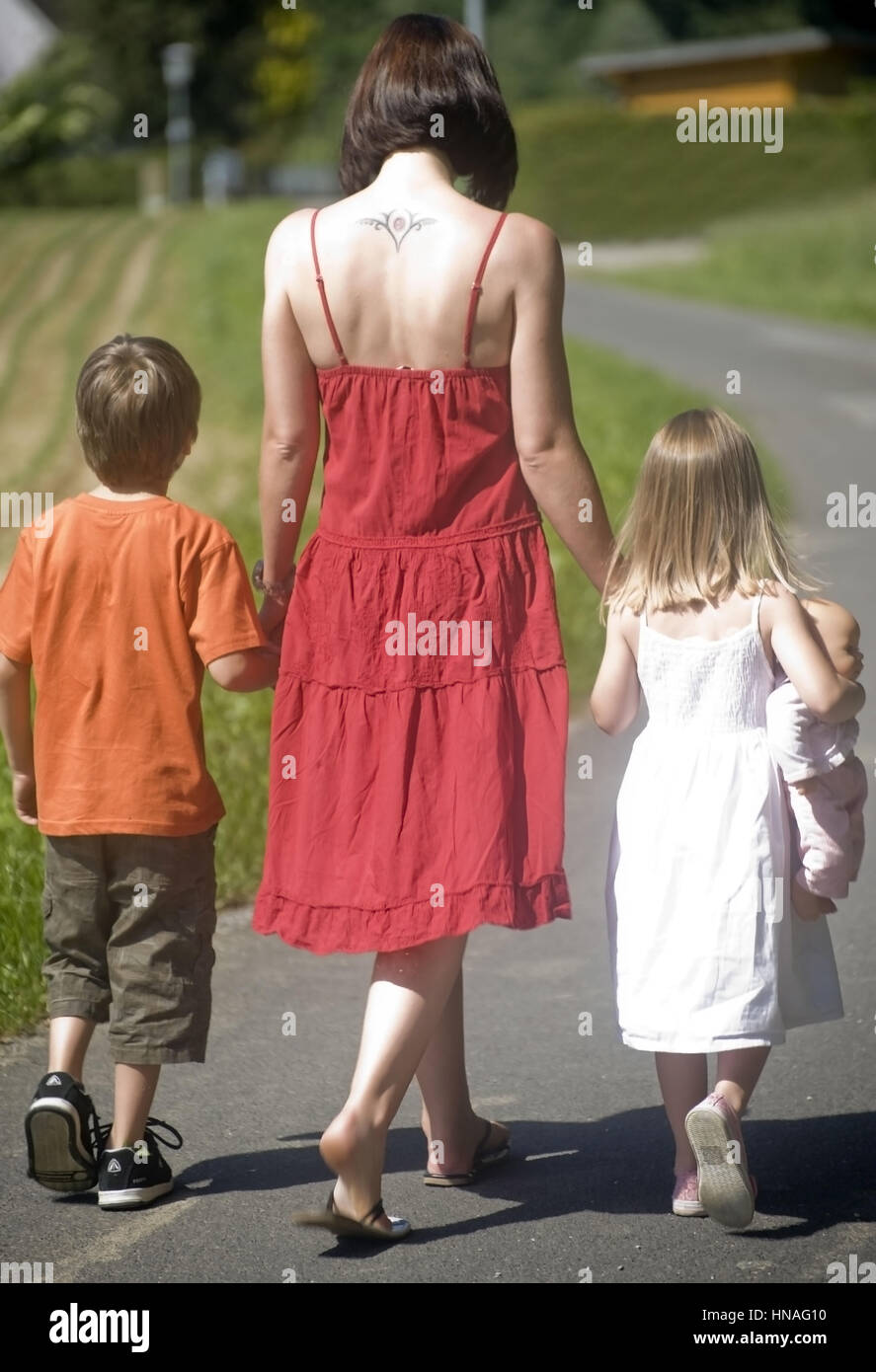 Children going on a walk with their parents hi-res stock photography ...