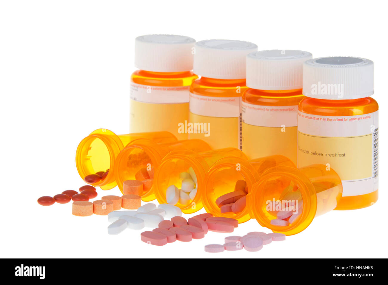 Many pills spilling out onto an isolated white background from orange ...