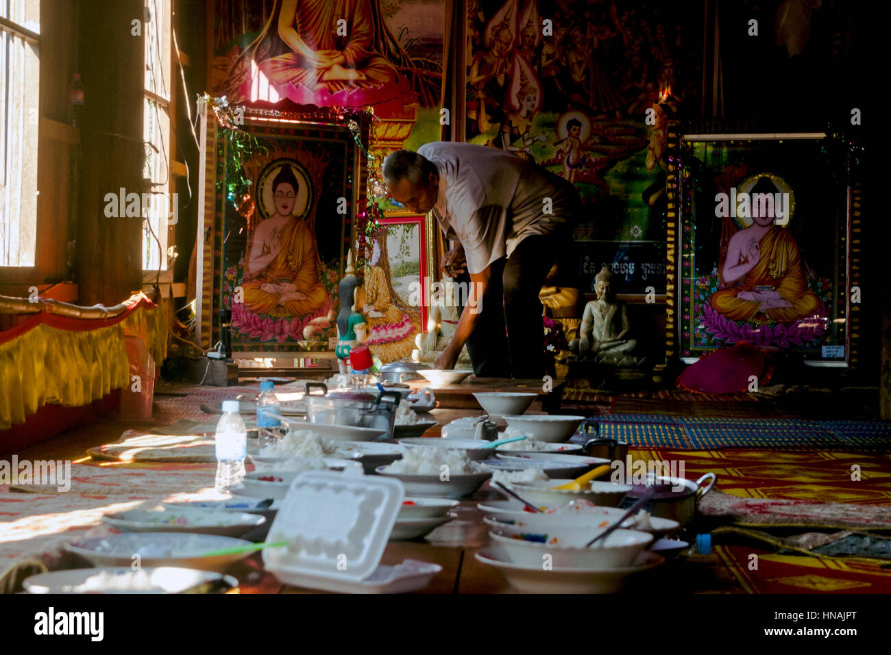 A Buddhist layman is getting food inside a pagoda during a ceremony in ...