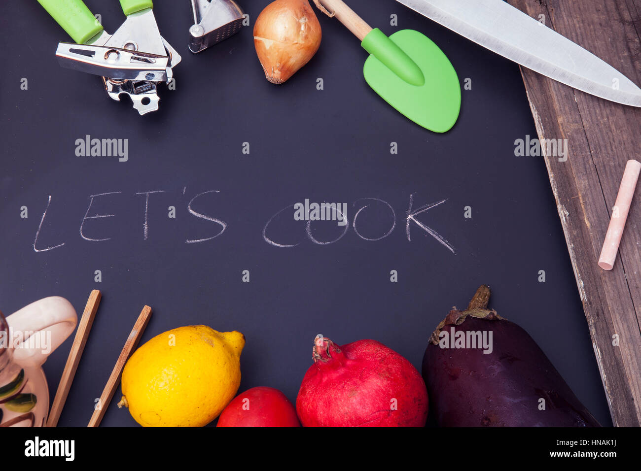 Let’s cook text written with white chalk on black chalkboard with ...