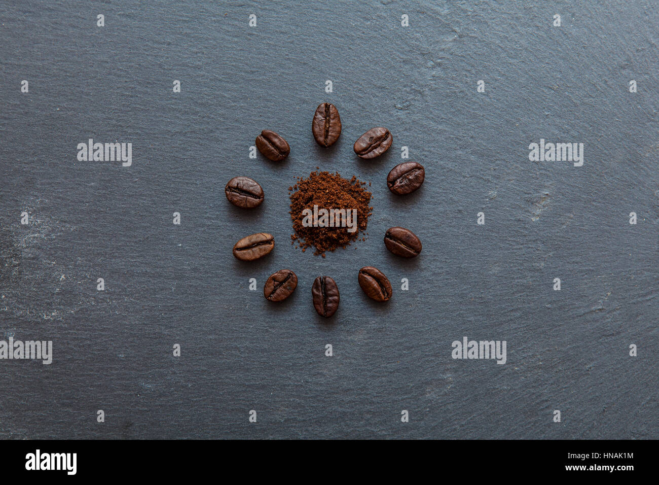 Coffee beans shaped as a flower with grinded coffee in the middle on a ...
