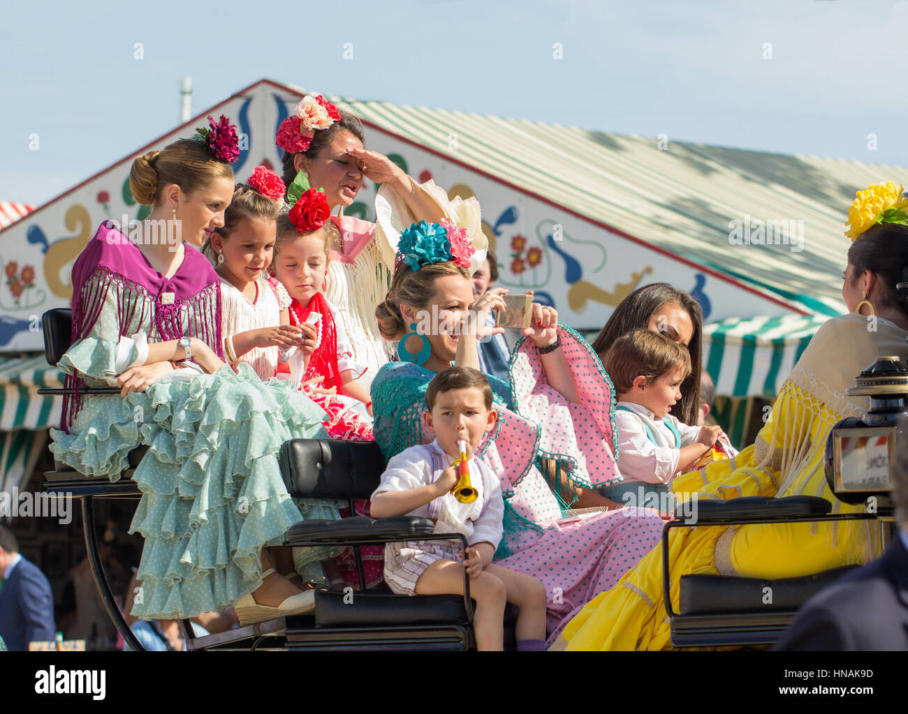 SEVILLE, SPAIN - APR, 25: people dressed in traditional costumes riding ...