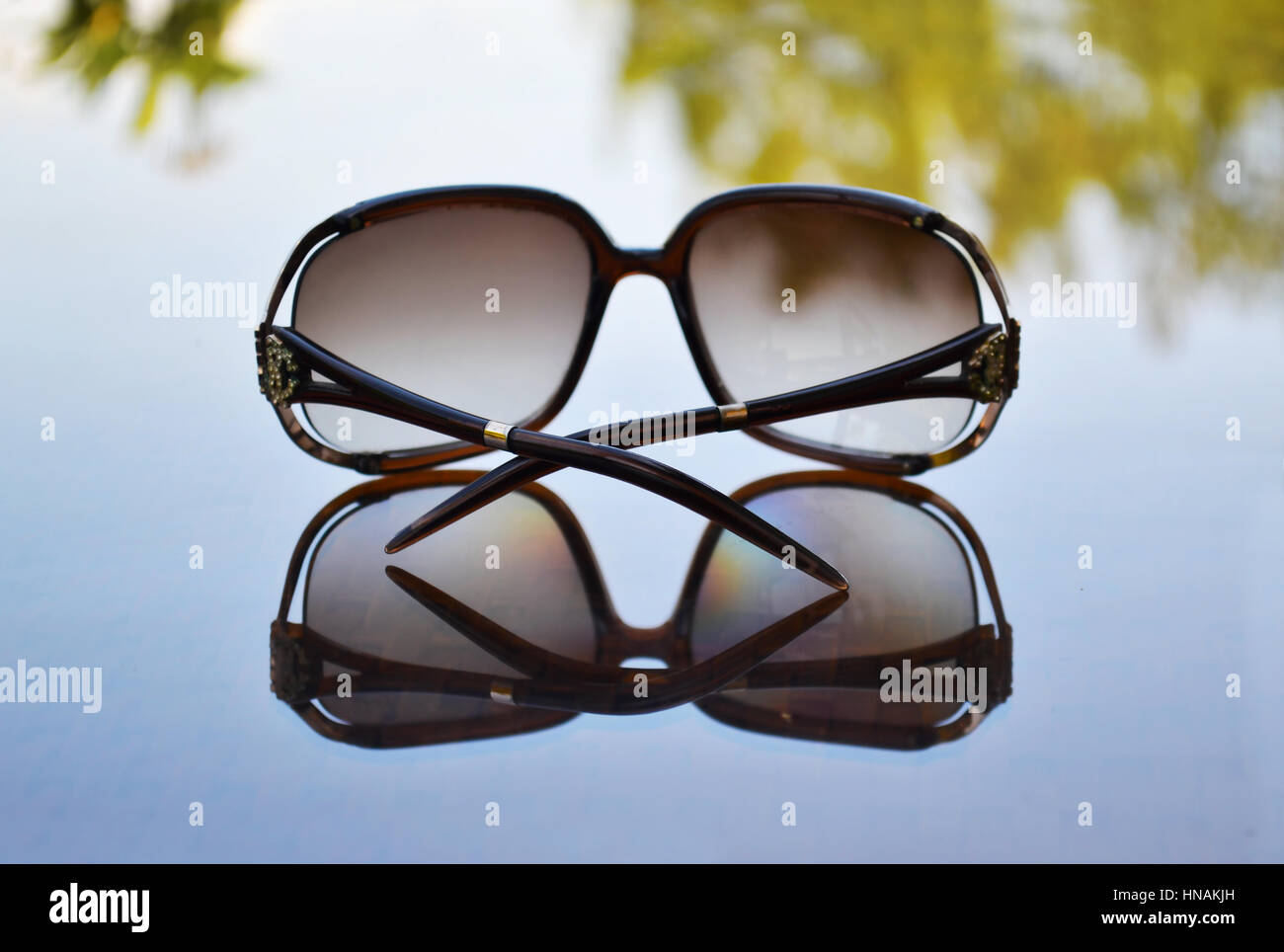 sunglasses reflection on table Stock Photo - Alamy