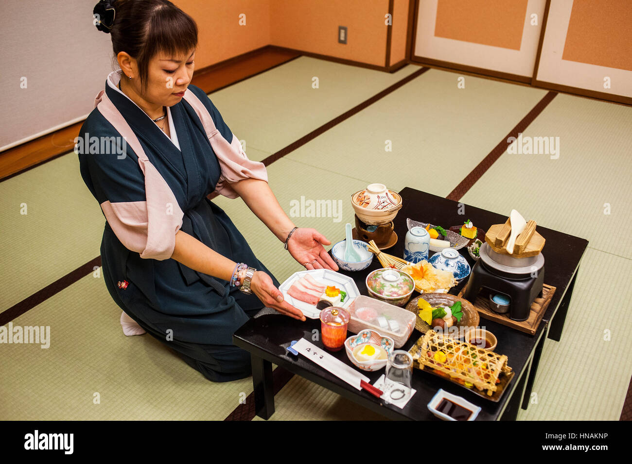 Waitress serving traditional food, Fujiya Ryokan accommodation, Kawayu ...