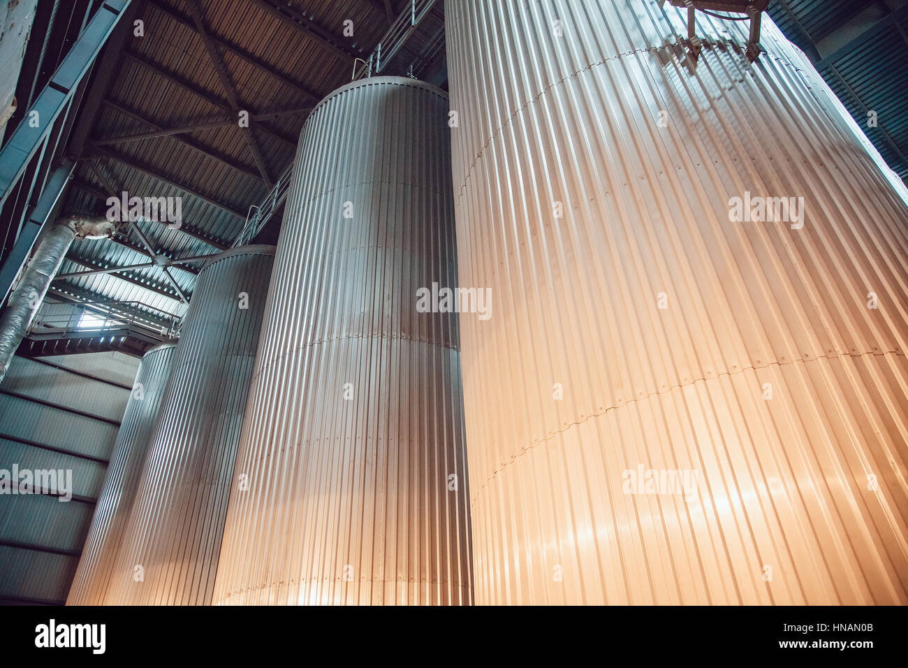 Modern beer plant, with brewing kettles, vessels, tubs and pipes made ...