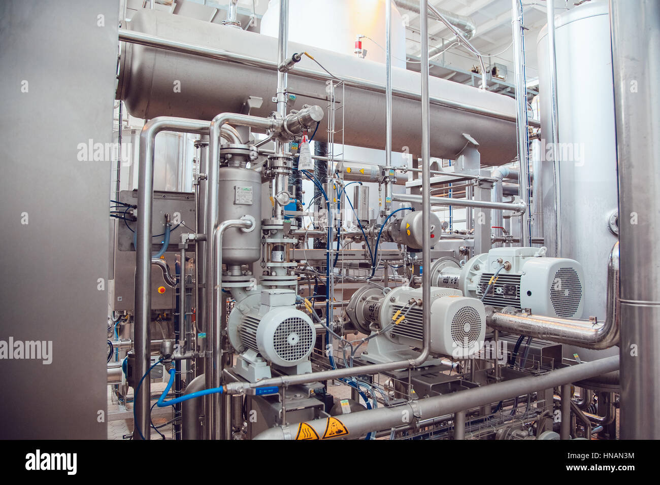 Modern beer plant, with brewing kettles, vessels, tubs and pipes made ...