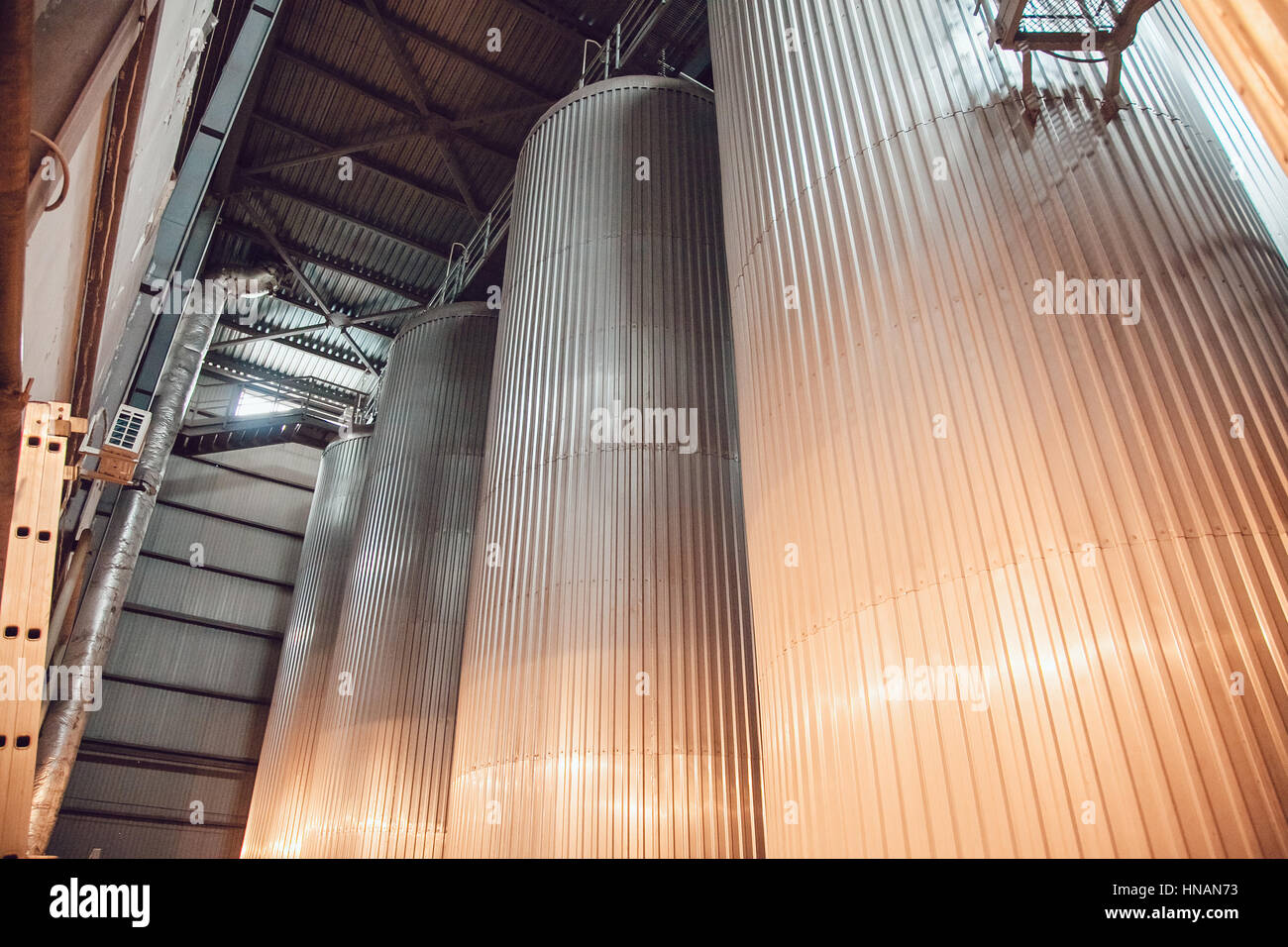 Modern beer plant, with brewing kettles, vessels, tubs and pipes made ...