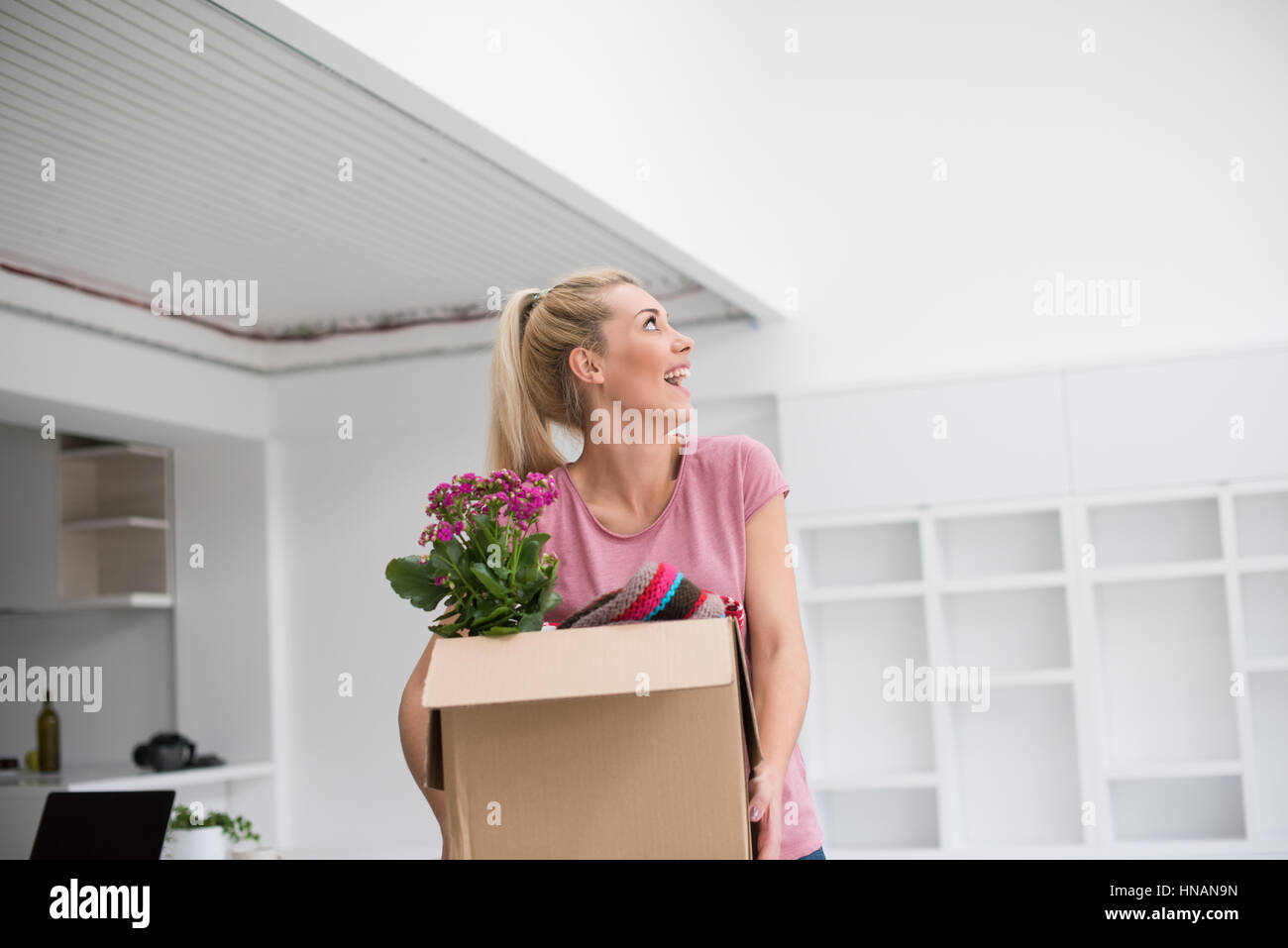 Beautiful girl moving in the new apartment Stock Photo - Alamy