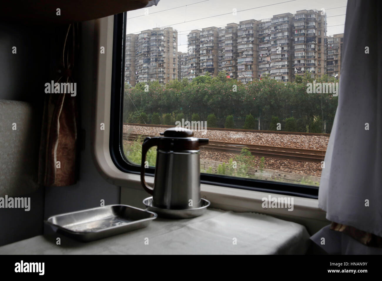A jug of hot water sits on a table on board a sleeper train as it ...