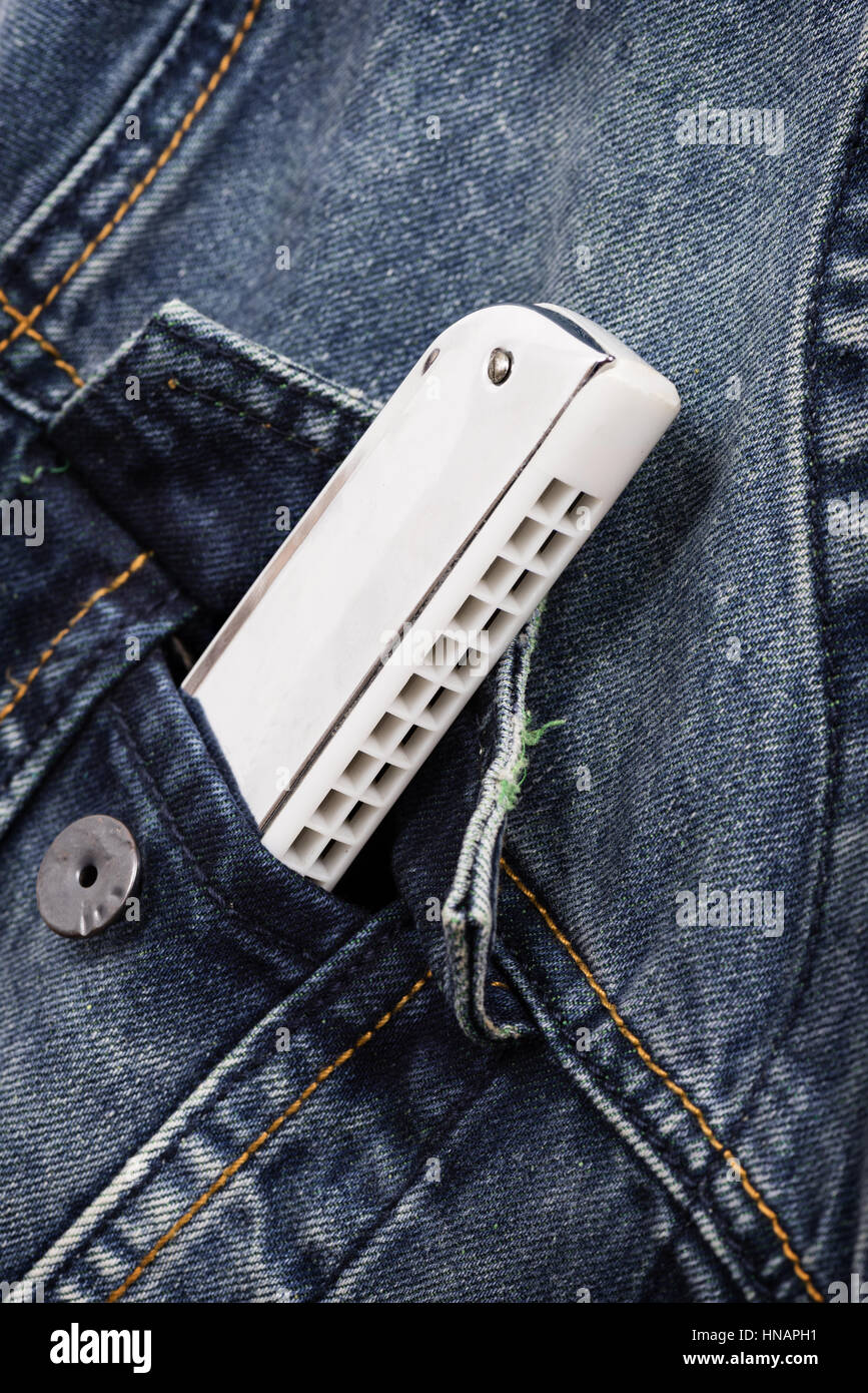 isolate harmonica in denim pocket Stock Photo - Alamy