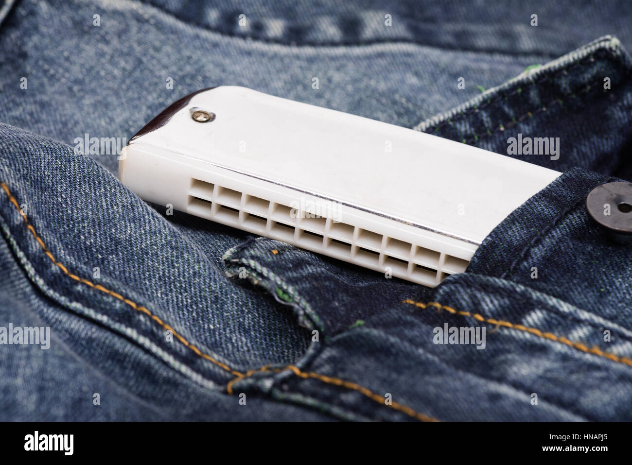 isolate harmonica in denim pocket Stock Photo - Alamy